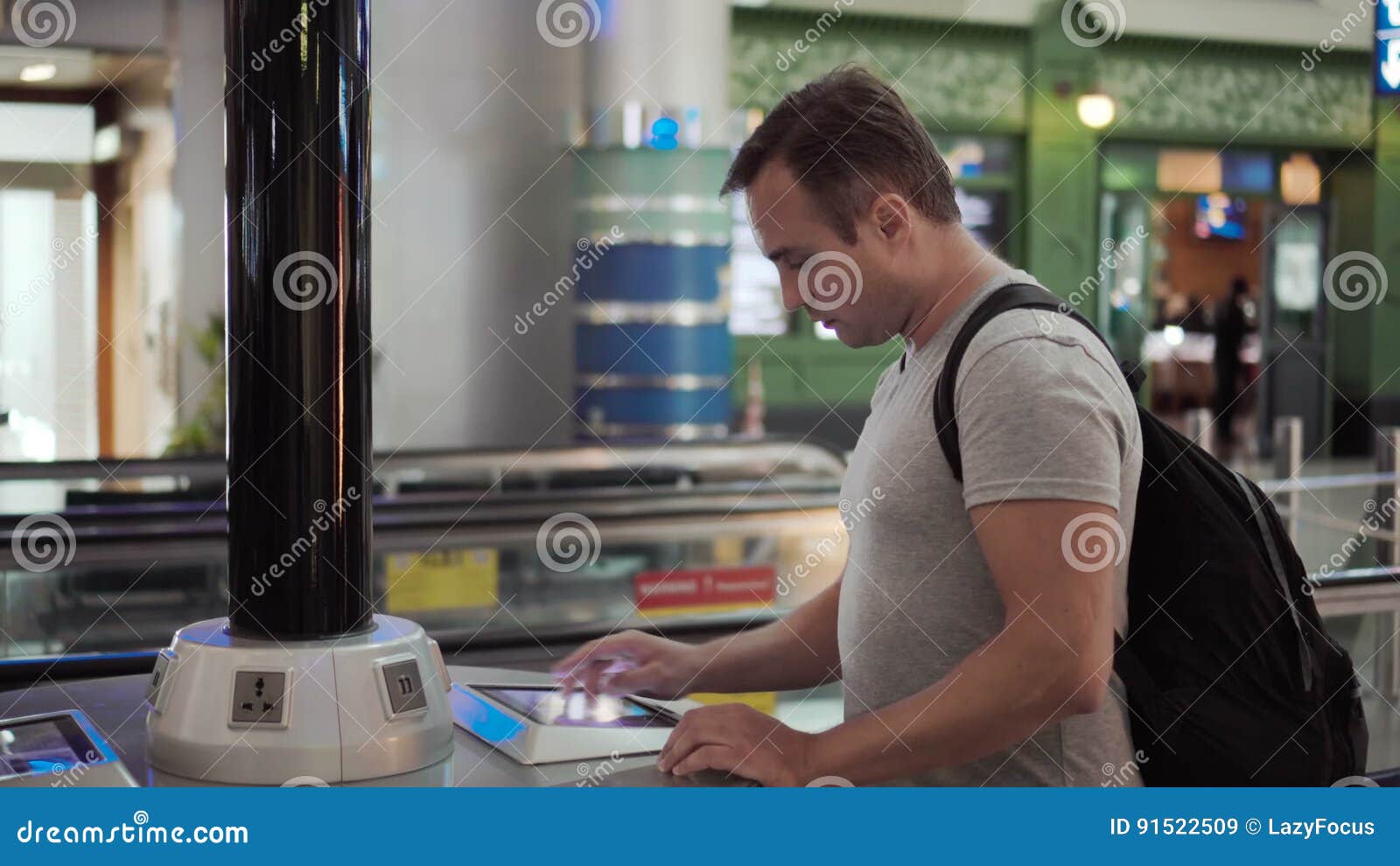 Handsome Young Man in Airport Terminal. Standing Near Charging Stand ...