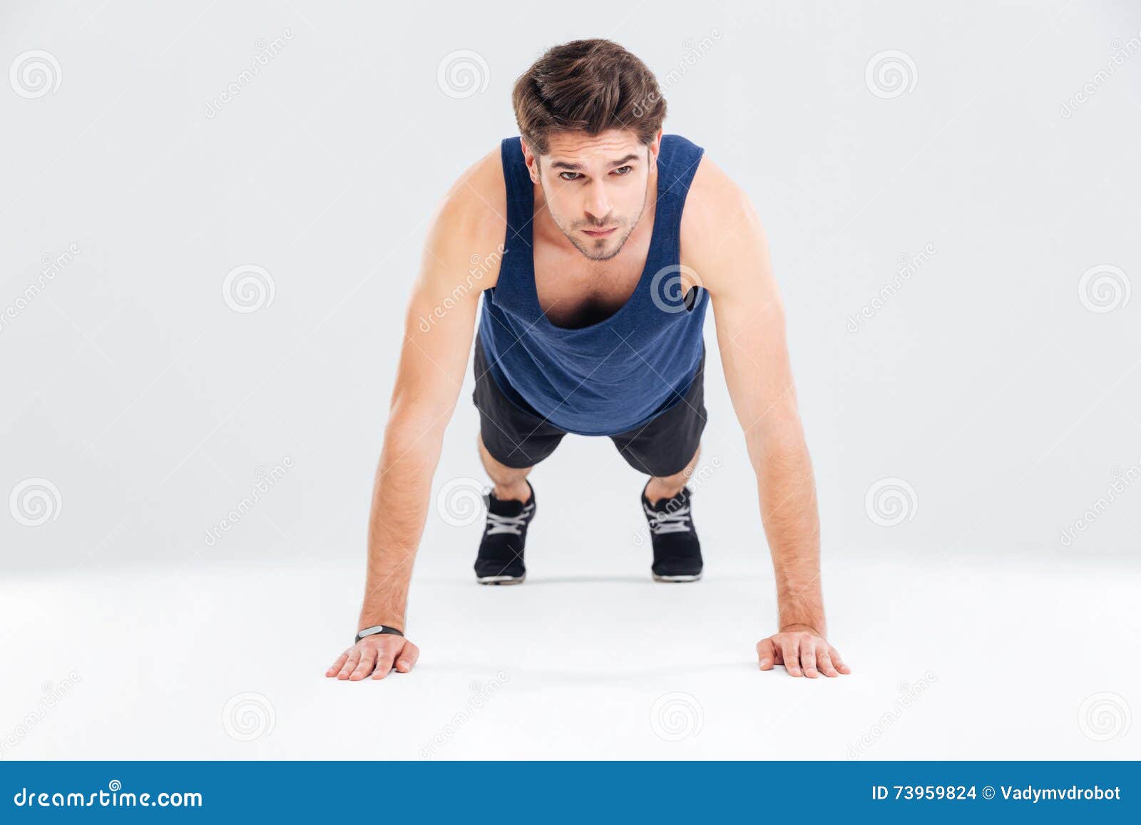 Handsome Young Man Athlete Training And Doing Plank Exercise Stock