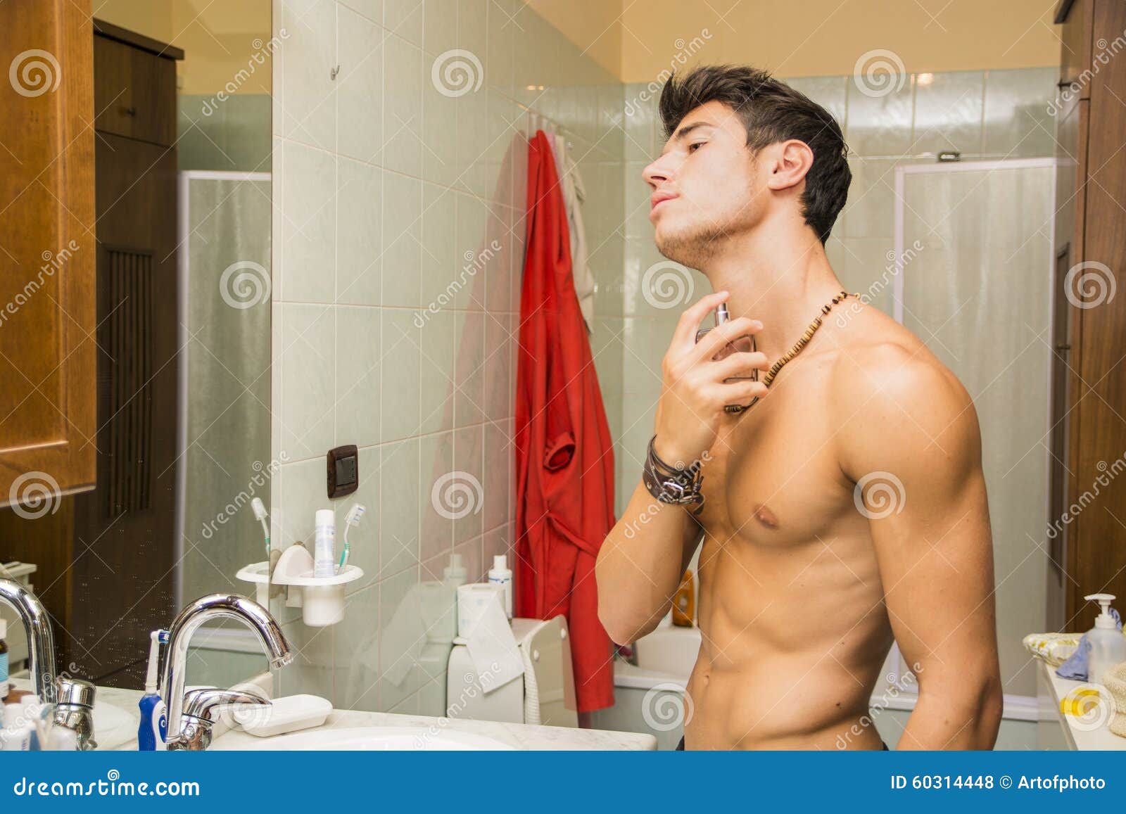 Handsome Young Man in Bathroom, Spraying Cologne Stock Photo - Image of ...