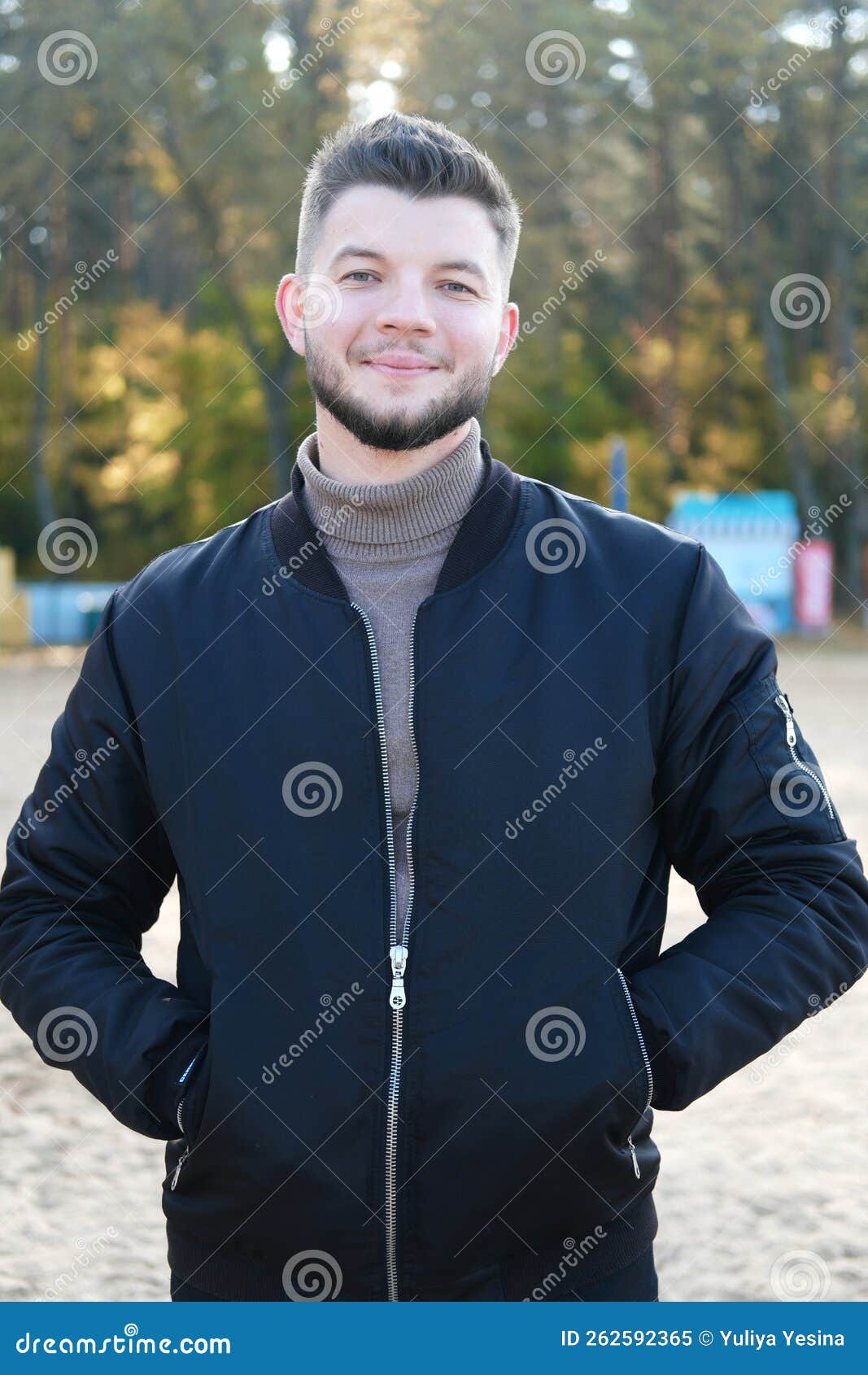 Handsome Young Man with a Beard and in a Black Jacket Posing on the ...