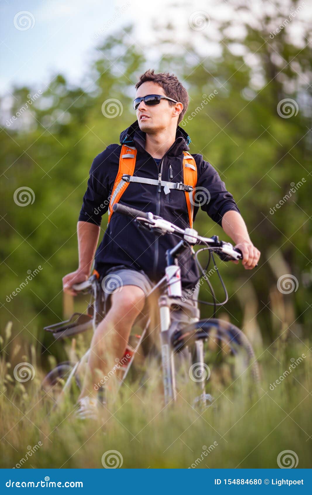 Handsome young man biking stock photo. Image of green - 154884680