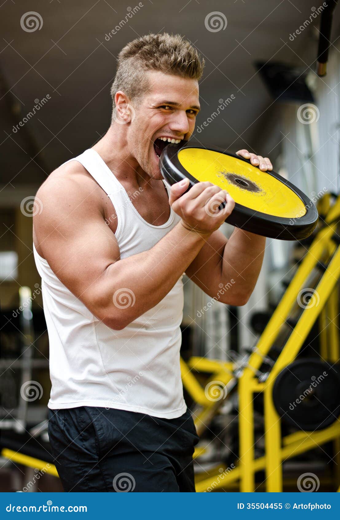 Handsome Young Man Biting Big Weight Disc in Gym Stock Image - Image of ...