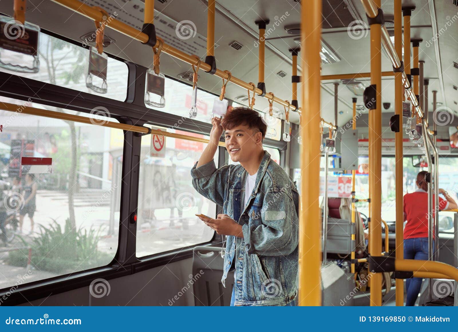 Handsome Young Man in a Blue Denim Jacket Using Smartphone in Bus Stock ...