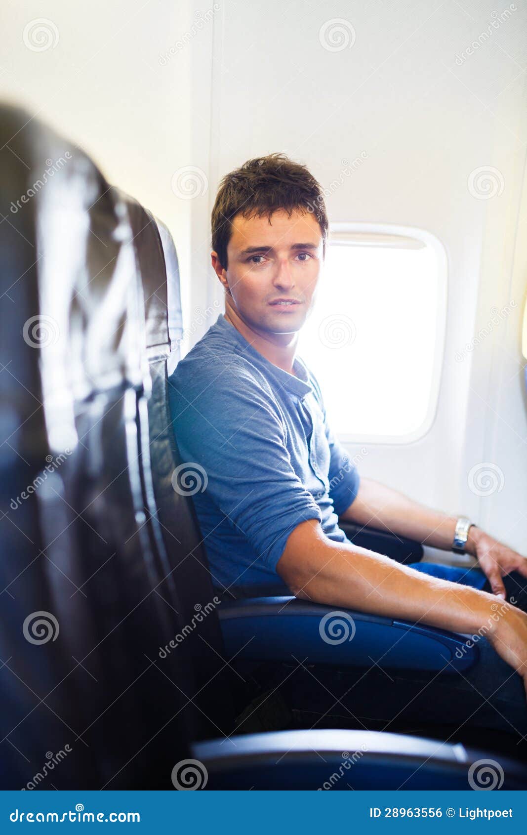 Handsome Young Man on Board of an Airplane during Flight Stock Photo ...