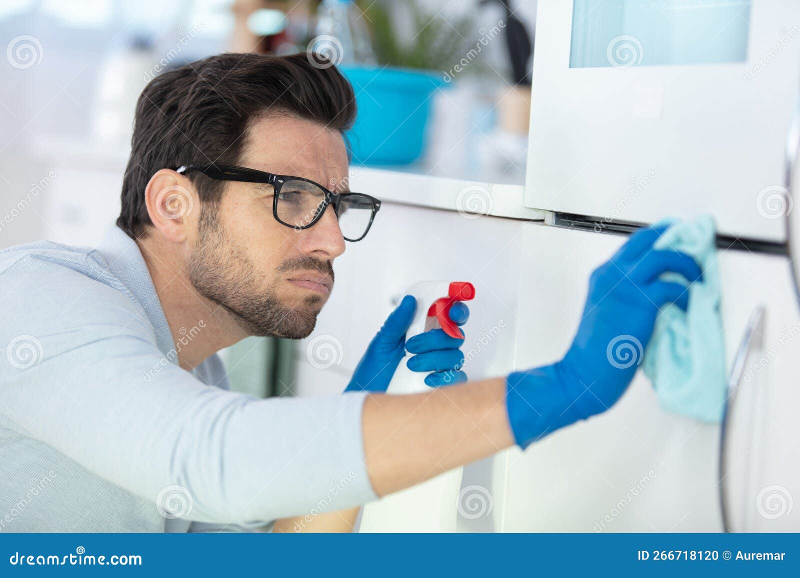 Handsome Young Man Cleaning Kitchen Cabinets Stock Photo - Image of ...
