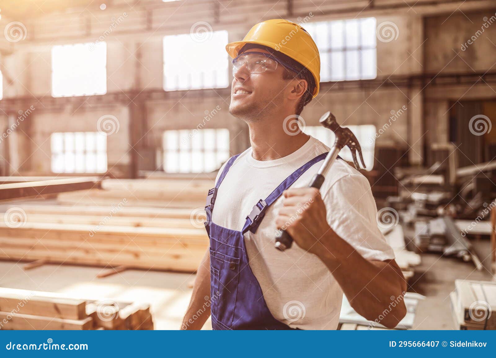 Cheerful Builder with Hammer Working at Construction Site Stock Image ...