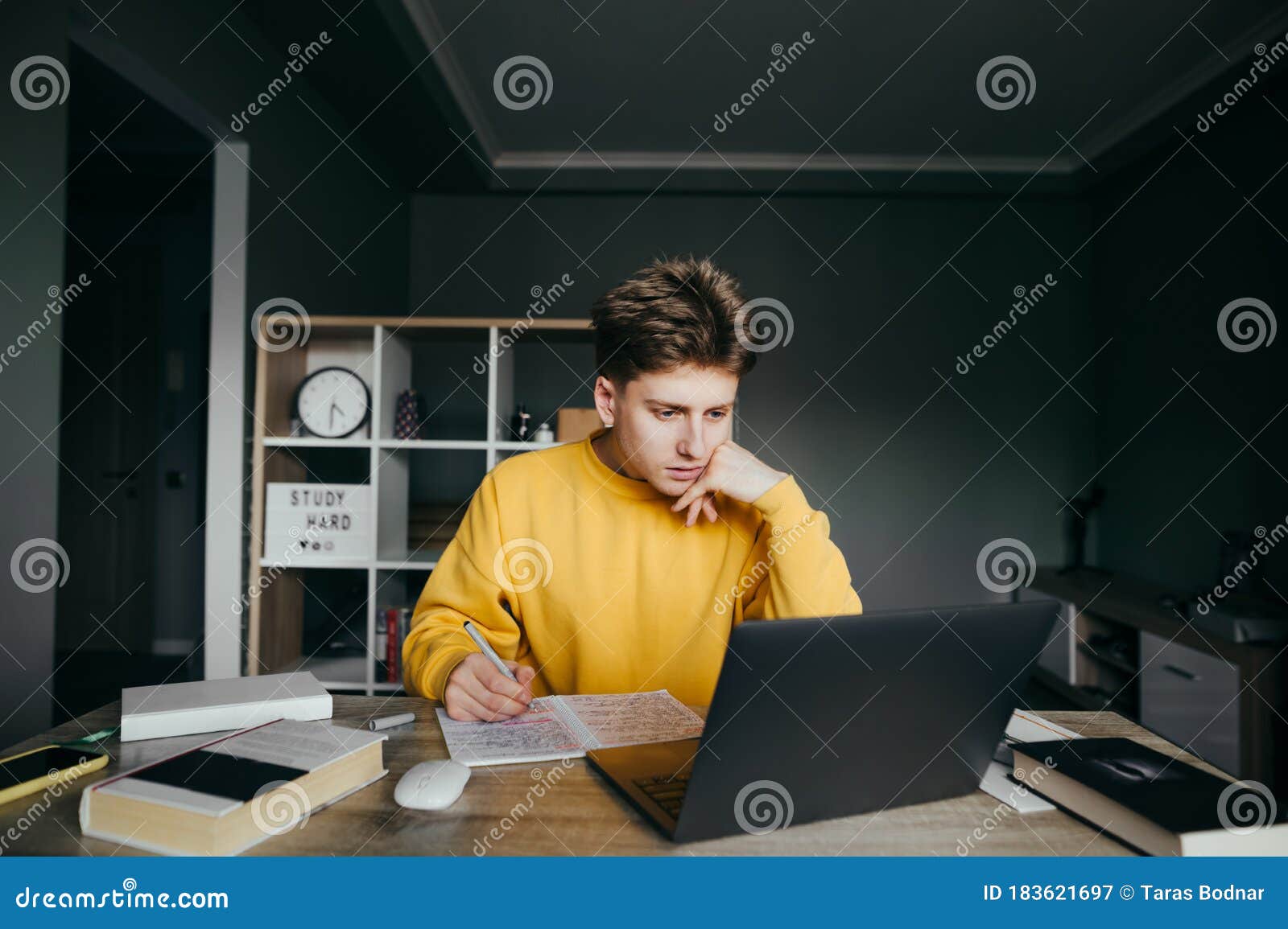Handsome Young Man Doing Homework on Desktop at Home on Room Background ...
