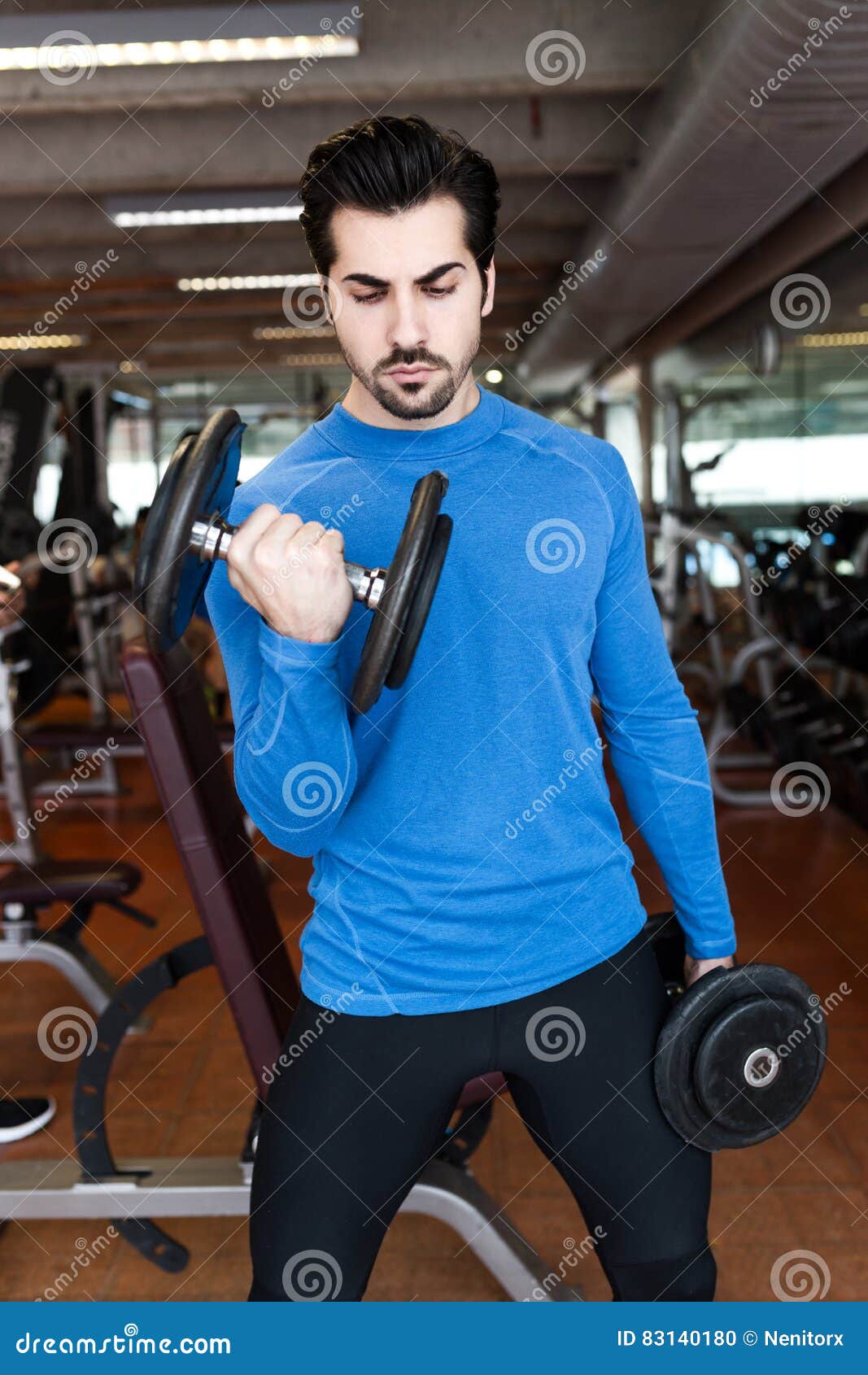 Handsome Young Man Doing Muscular Exercise in Gym. Stock Photo - Image ...