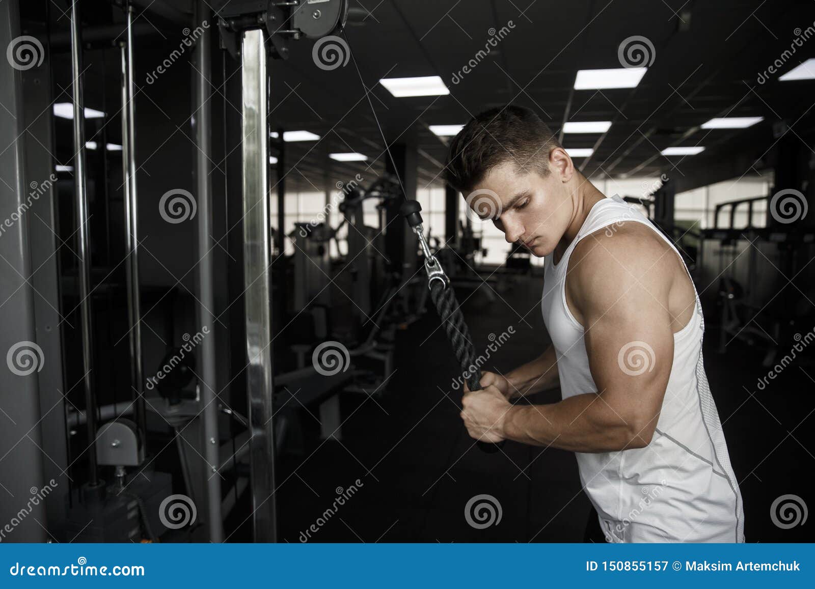 Handsome Young Man Doing Sports. he Trains in the Gym Stock Image ...