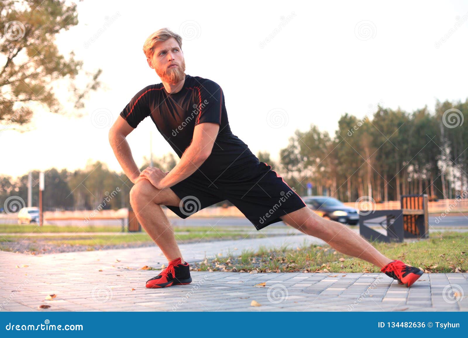 Handsome Young Man Doing Stretching Exercises before Running while ...