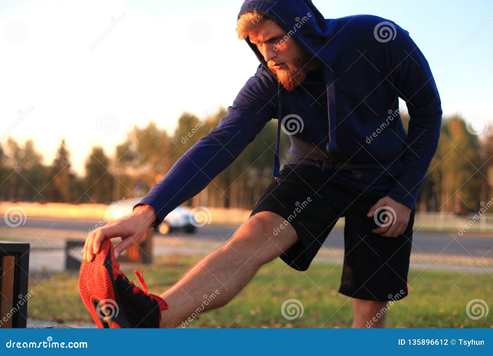 Handsome Young Man Doing Stretching Exercises before Running while ...