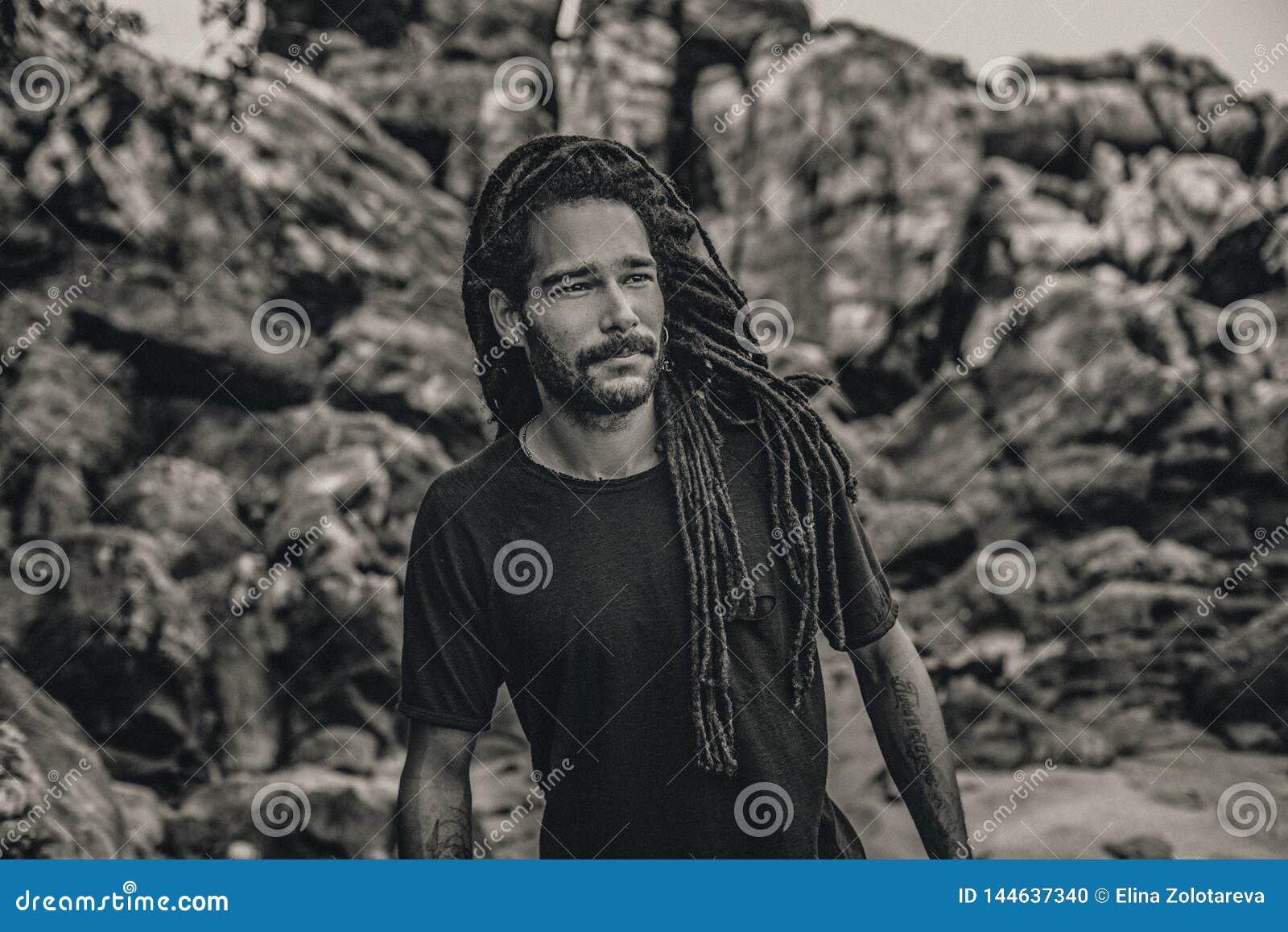 Handsome Young Man with Dreadlocks Outdoors. Male Model at the Rocks ...