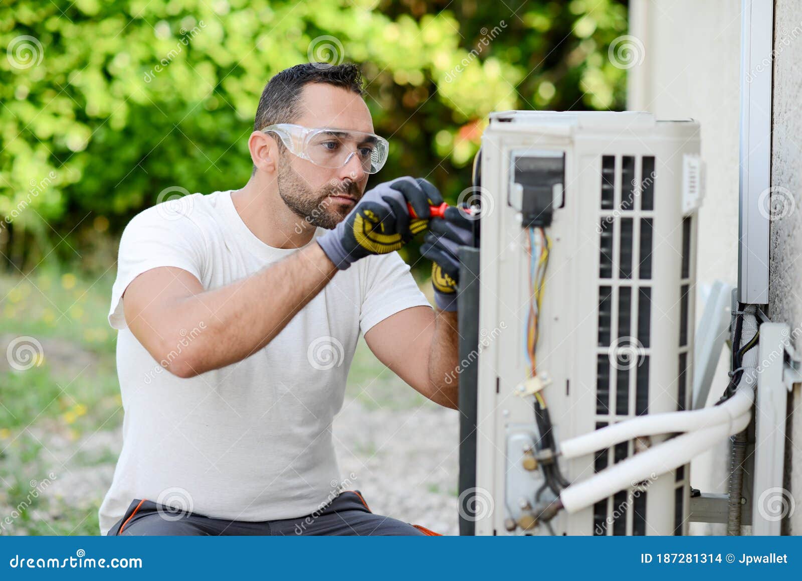 Handsome Young Man Electrician Installing Air Conditioning in a Client ...