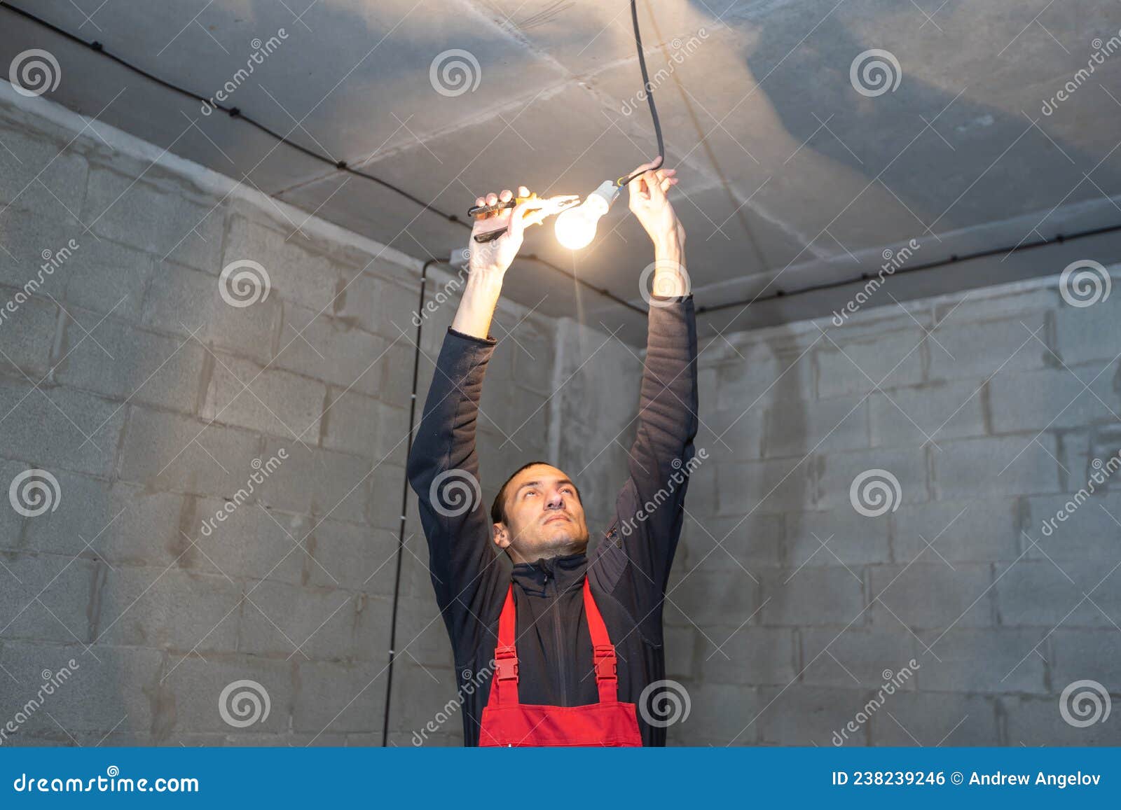 Handsome Young Man Electrician Working on Switchboard of House Building ...