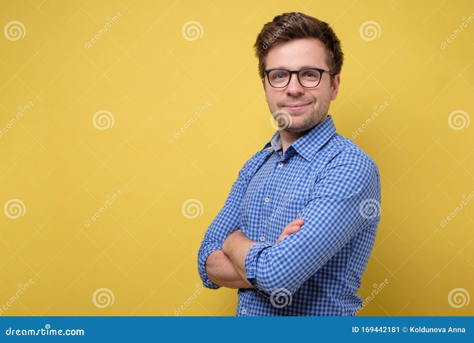 Handsome Young Man with Folded Hands Smiling Against Yellow Background ... Handsome Young Man with Folded Hands Smiling Against Yellow Background ...