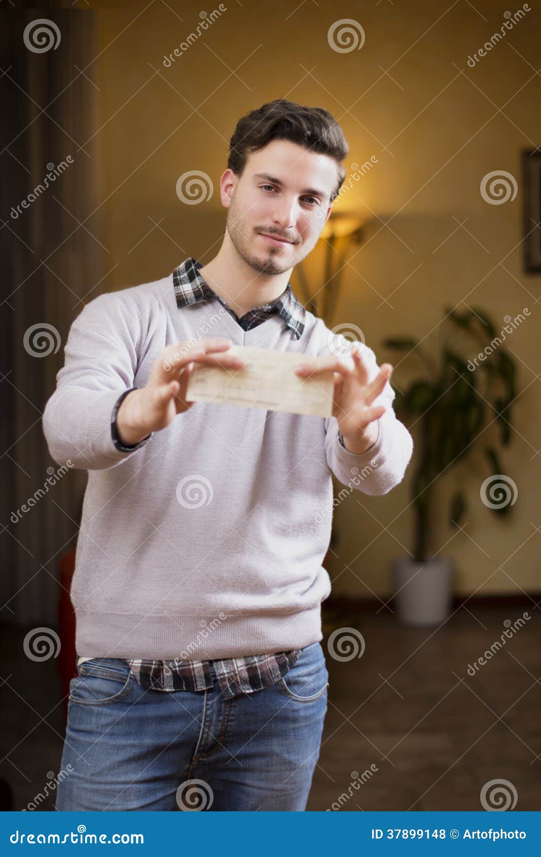 Handsome Young Man Holding Check in His Hands Stock Photo - Image of ...