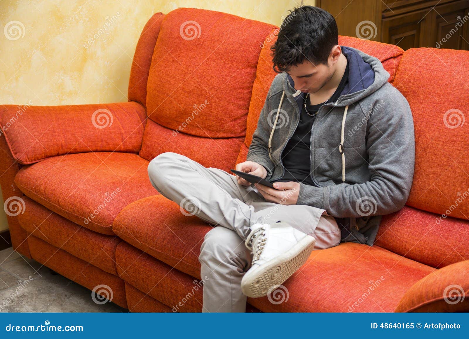 Handsome Young Man at Home Reading with Ebook Stock Image - Image of ...