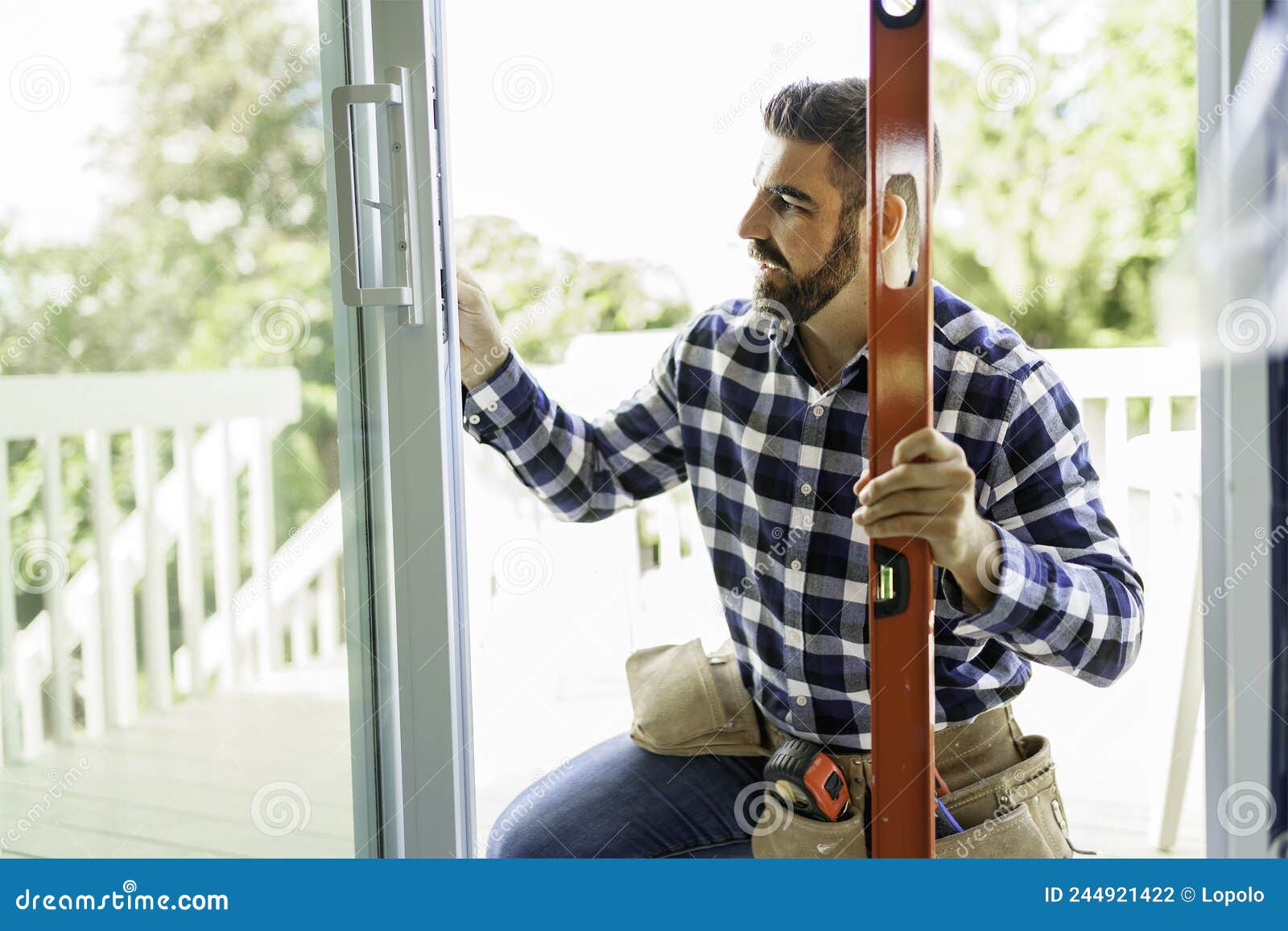 Handsome Young Man Installing Bay Window in a New House Construction ...
