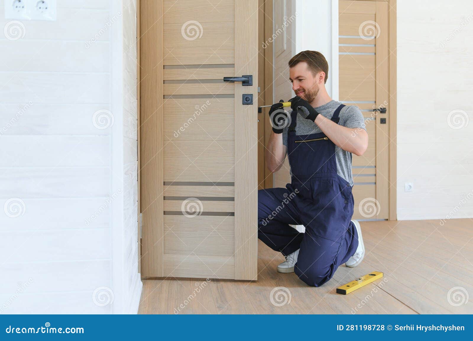 Handsome Young Man Installing a Door in a New House Construction Site ...