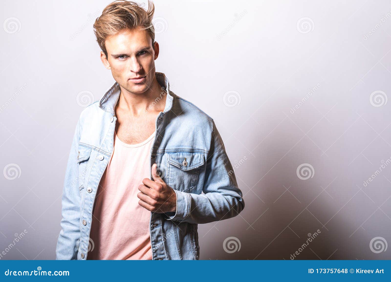 Handsome Young Man in Jeans Jacket Pose in Studio. Stock Photo - Image ...