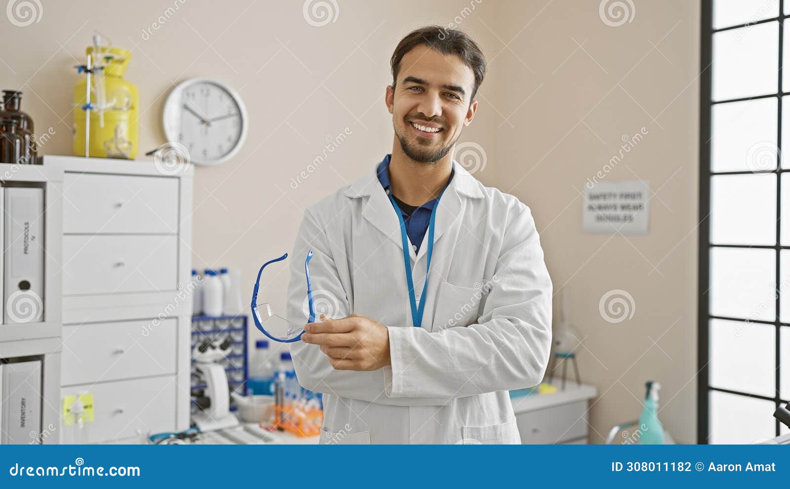 Handsome Young Man in Lab Coat Smiling Indoors at a Modern Laboratory ...