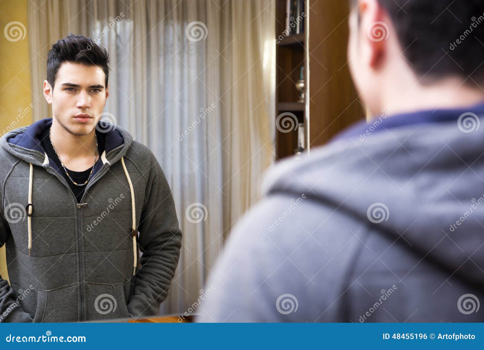 Handsome Young Man Looking at Himself in Mirror at Stock Photo - Image ...