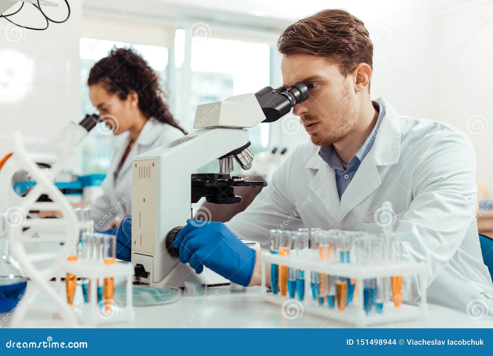 Handsome Young Man Looking into the Microscope Stock Photo - Image of ...