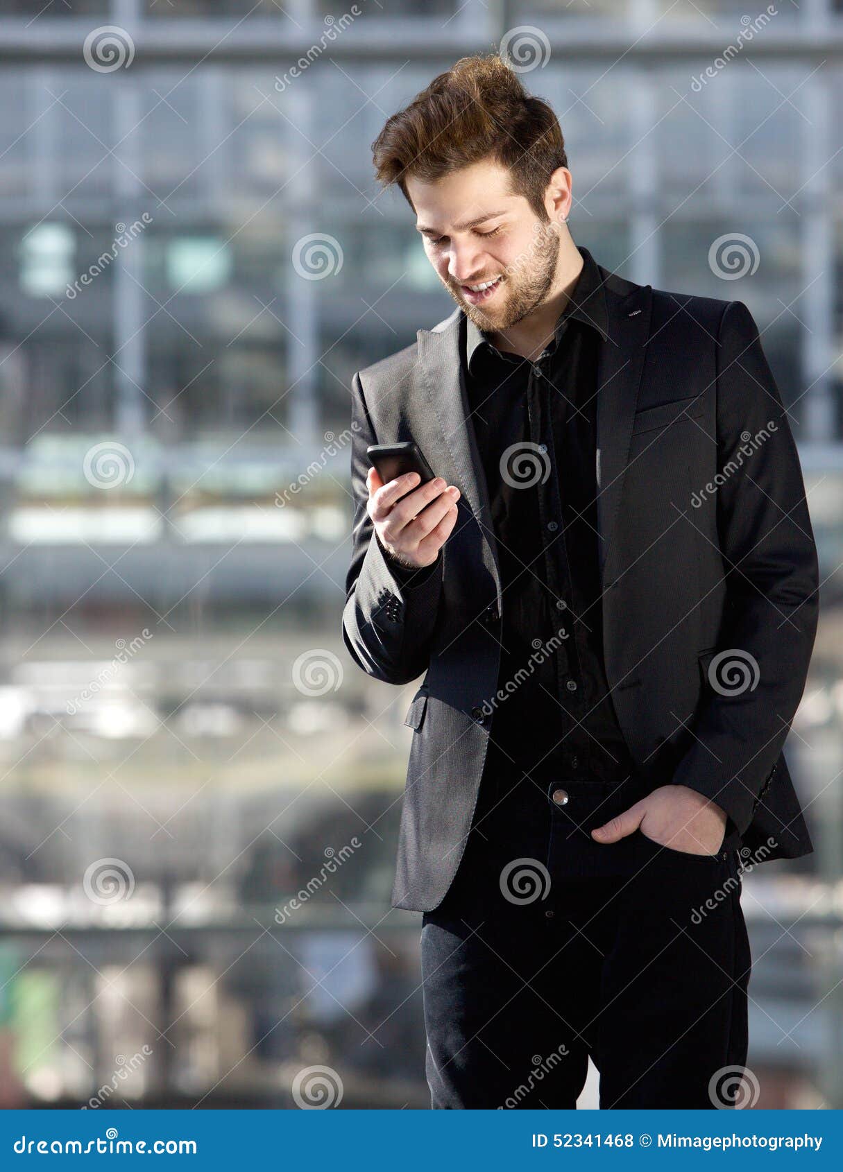 Handsome Young Man Looking at Mobile Phone Text Message Stock Photo ...