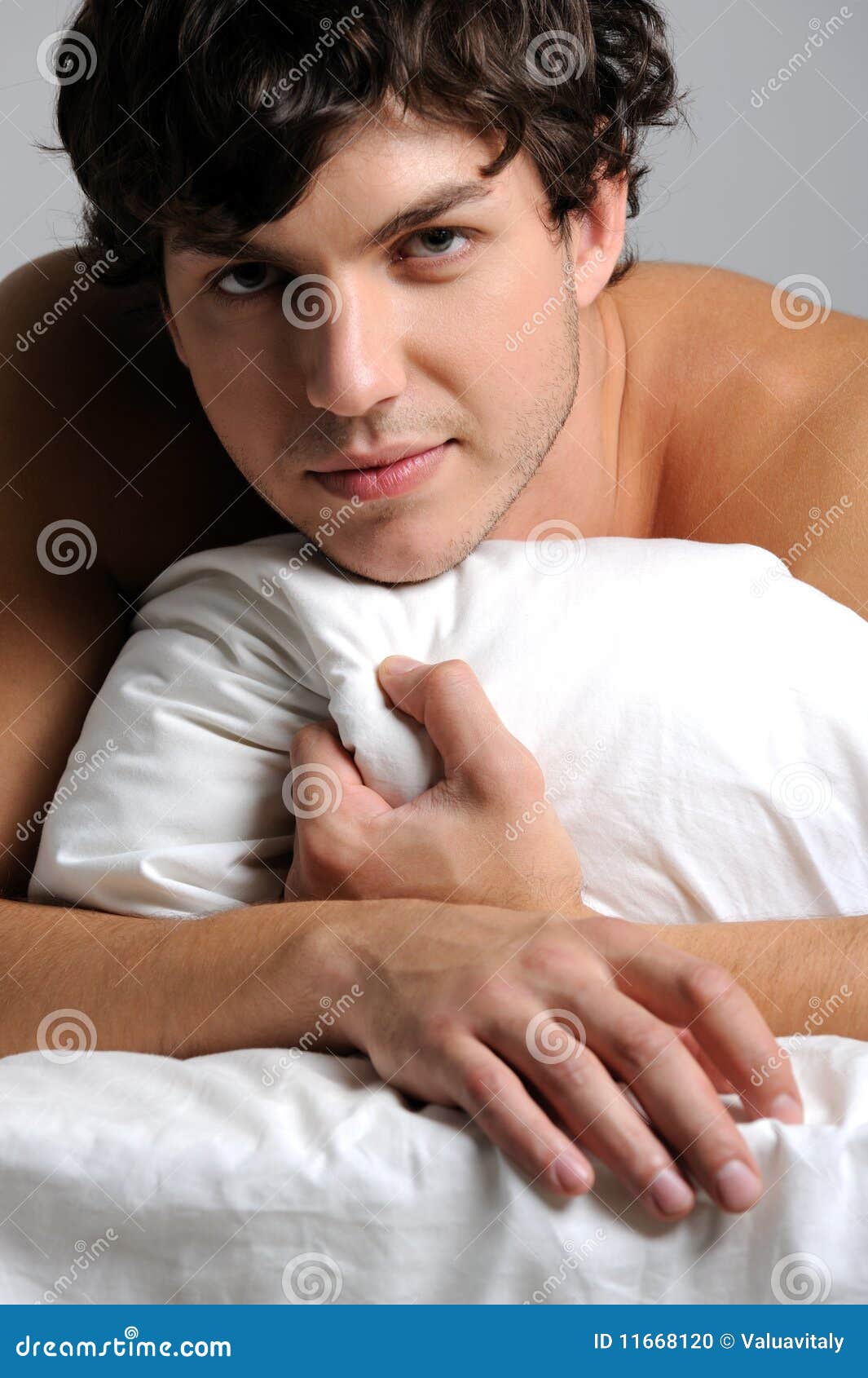 Handsome Young Man Lying in Bed with Pillow Stock Photo - Image of male ...