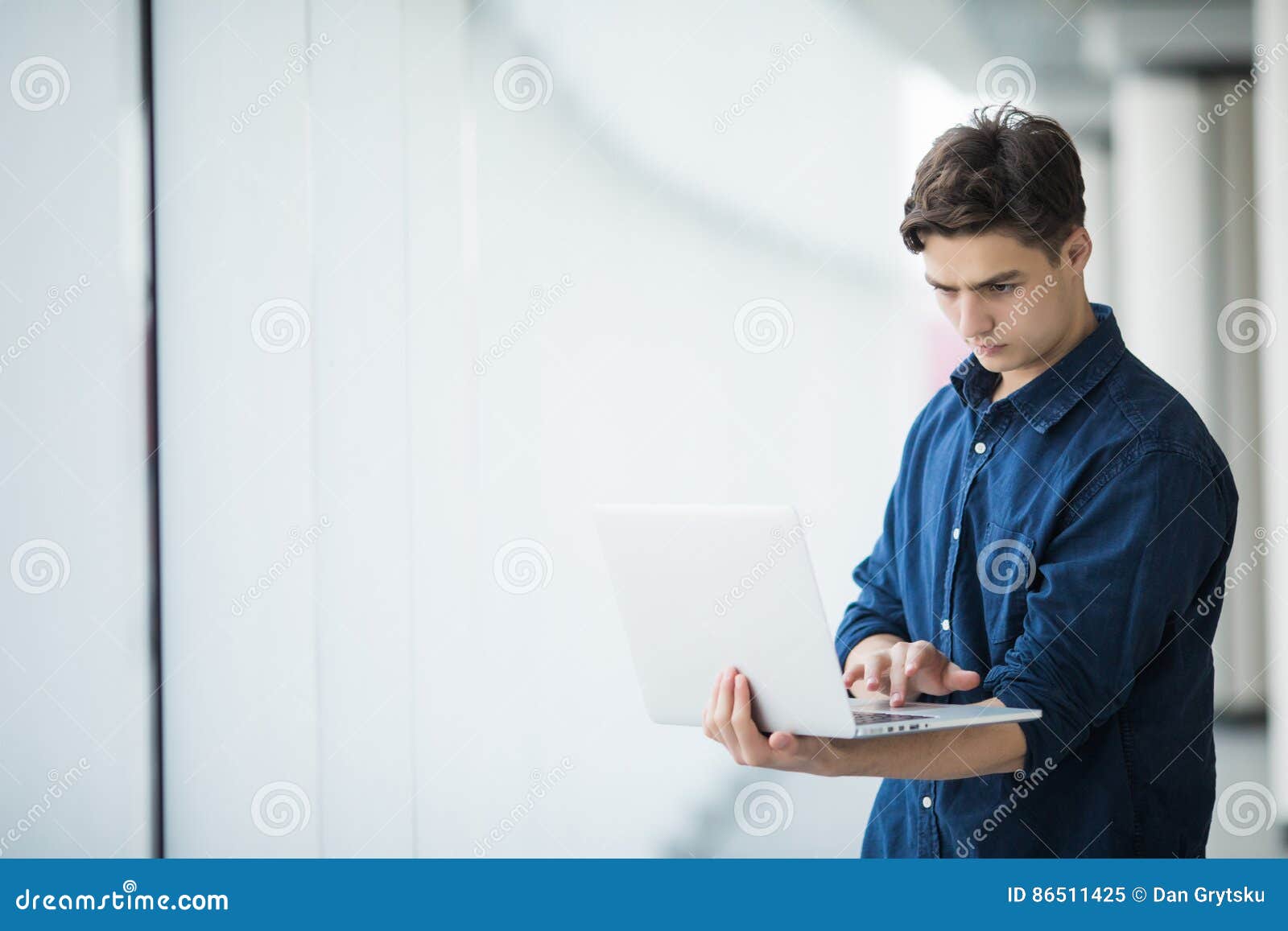 Handsome Young Man Man Holding a Laptop in Hall Stock Image - Image of ...