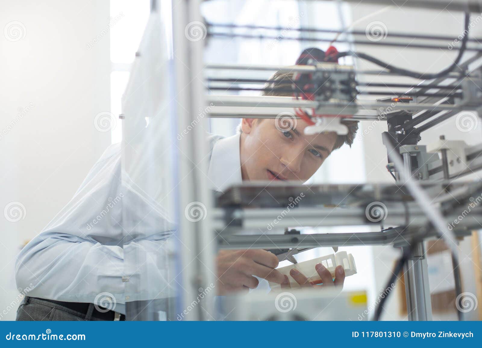 Handsome Young Man Measuring Model with Caliper Stock Photo - Image of ...