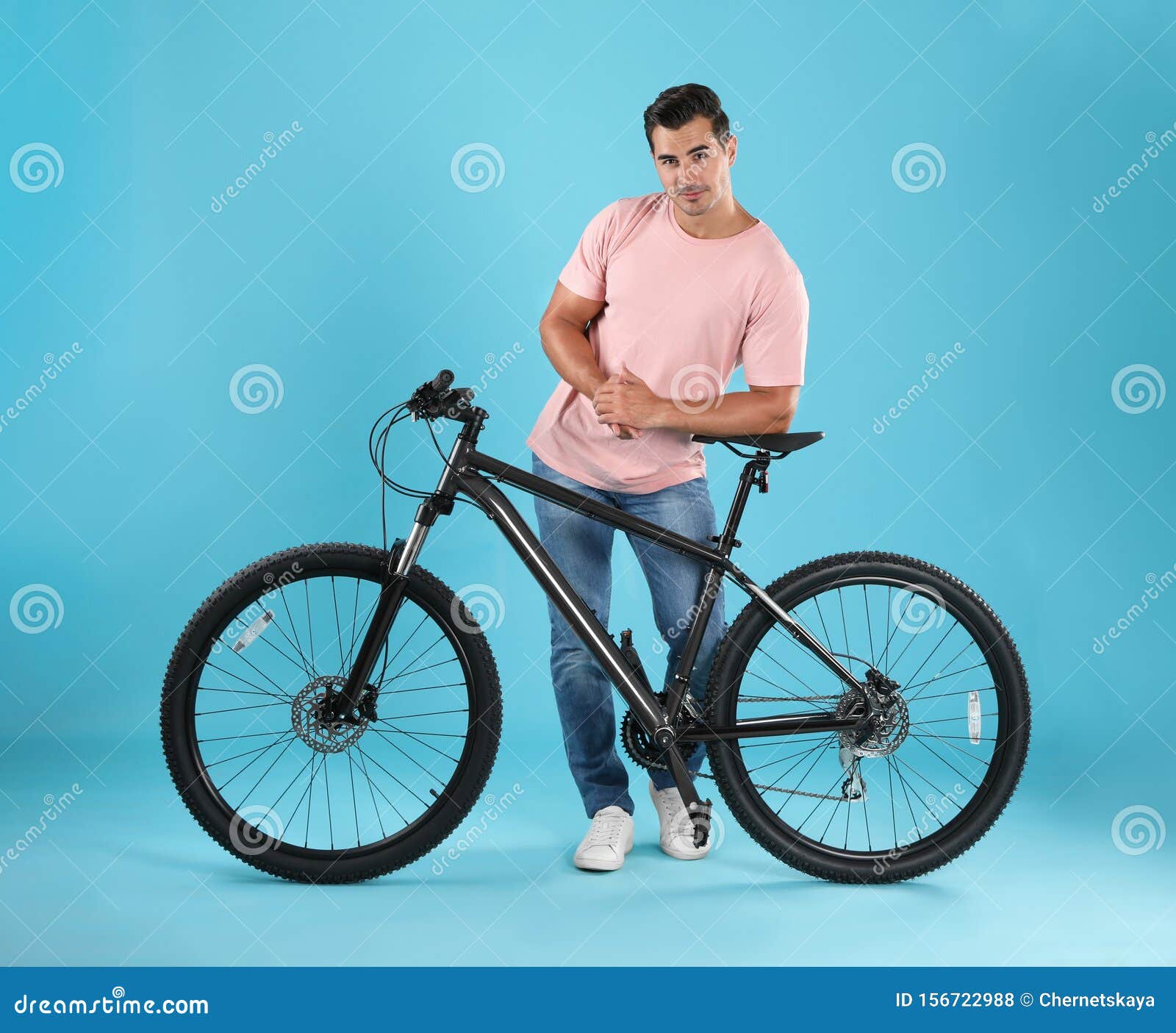 Handsome Young Man with Modern Bicycle on Blue Background Stock Photo ...