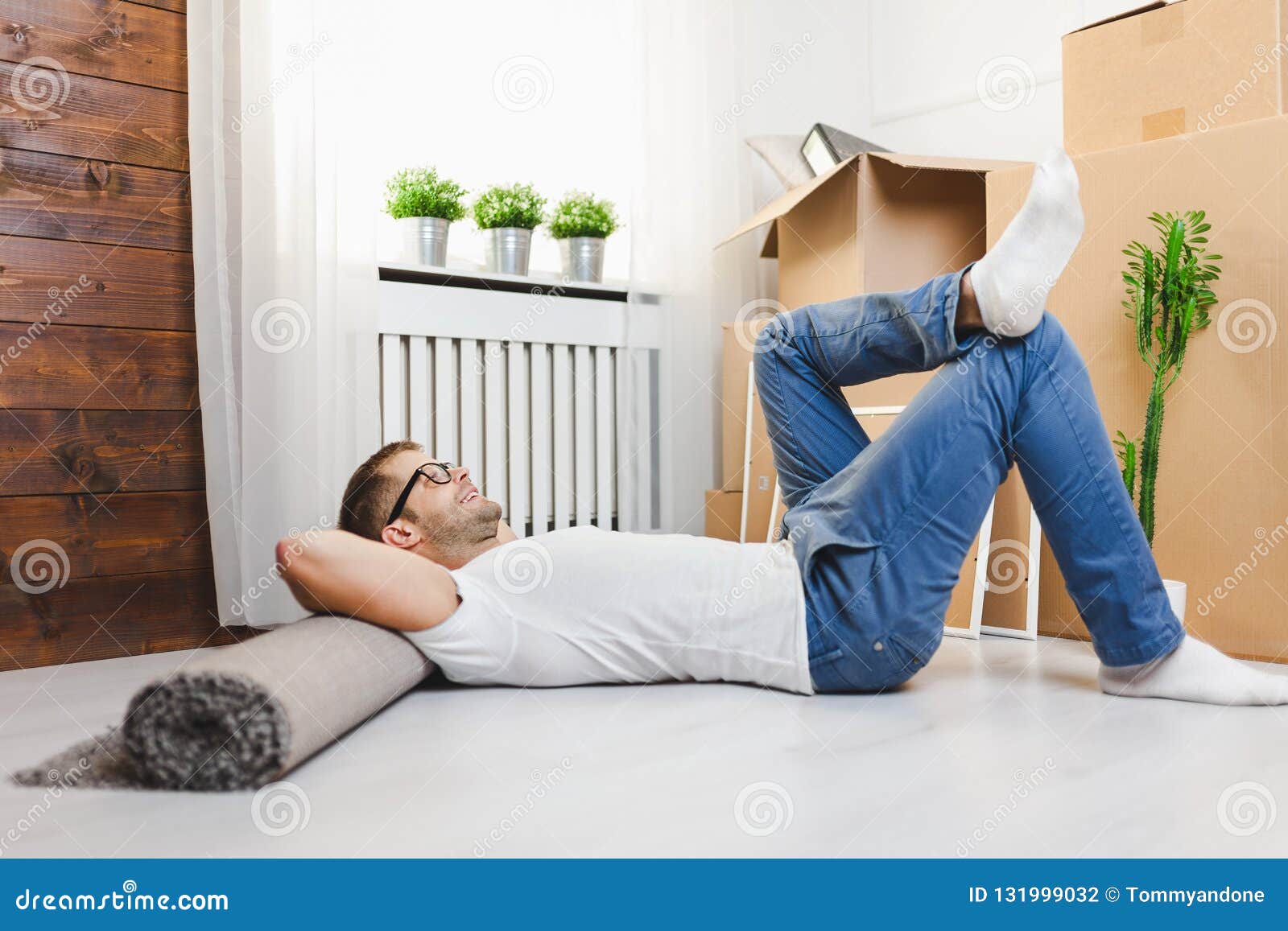 Handsome Young Man Moving To a New Home Stock Photo - Image of living ...
