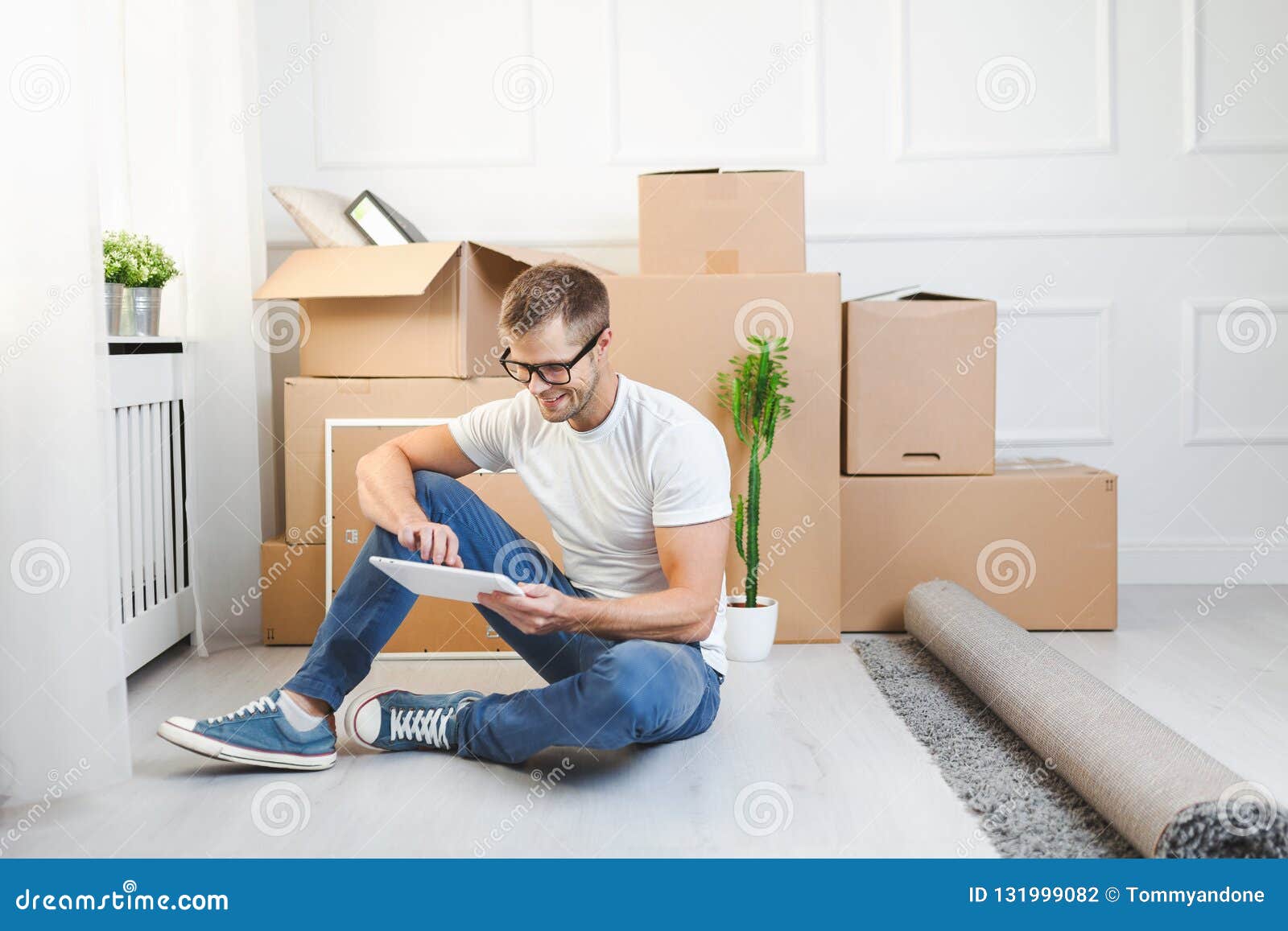 Handsome Young Man Moving To a New Home Stock Photo - Image of property ...