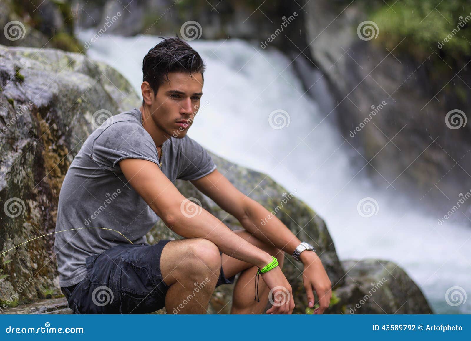 Handsome Young Man Near Mountain Waterfall on Rock Stock Photo - Image ...