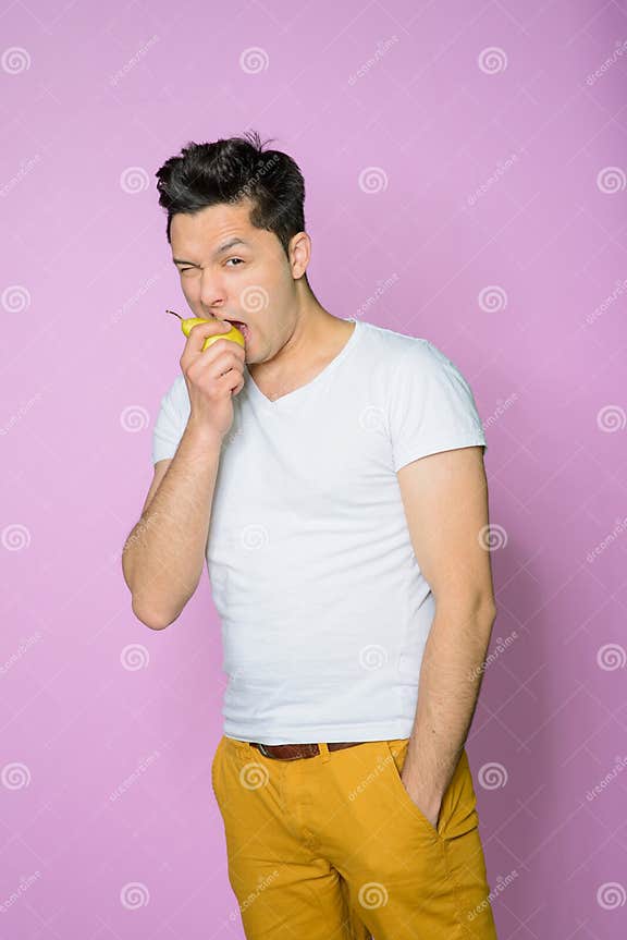 Handsome Young Man with a Pear Stock Image - Image of holding ...