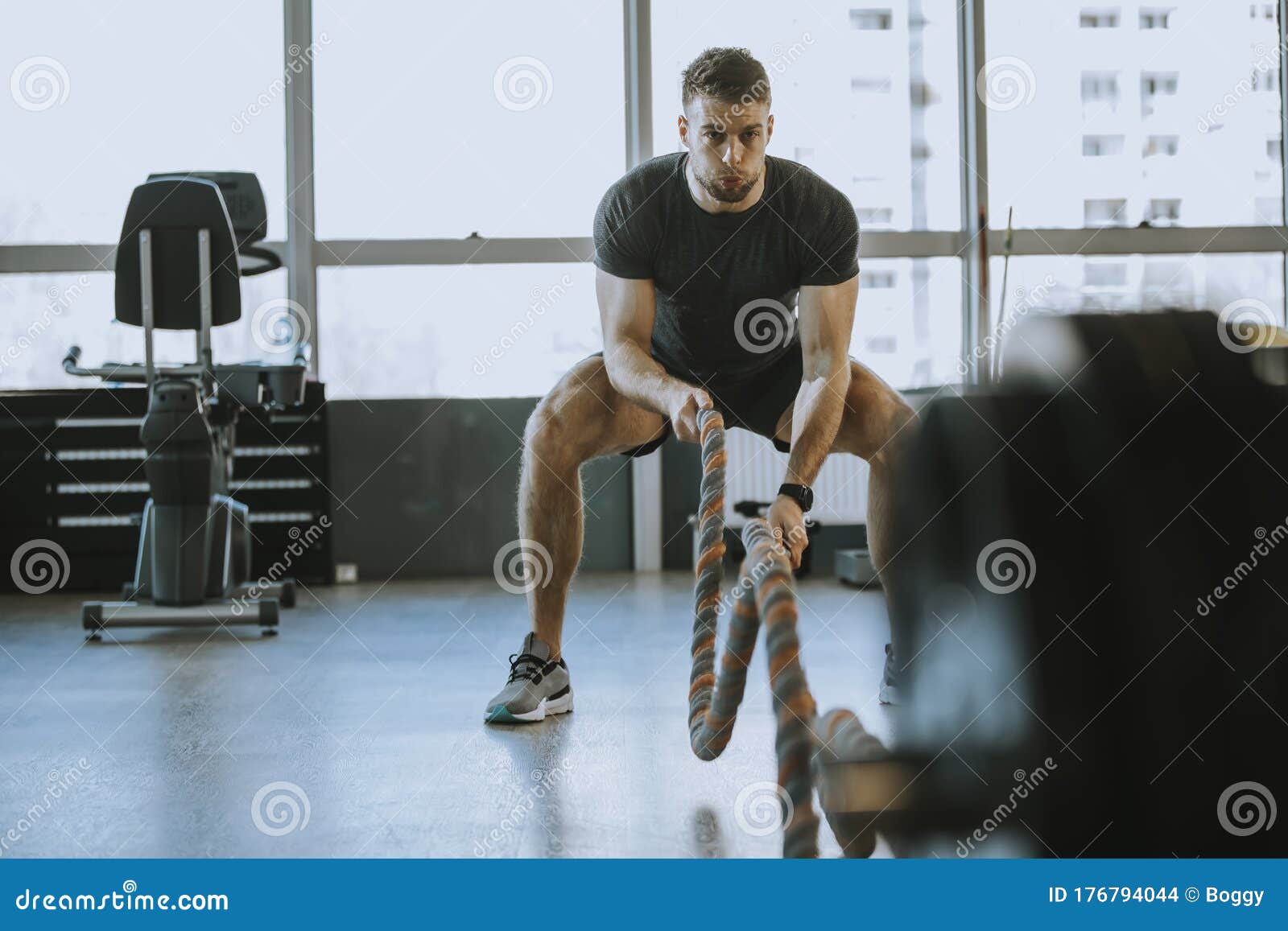Young Man Practicing with Battle Ropes in the Gym Stock Photo - Image ...