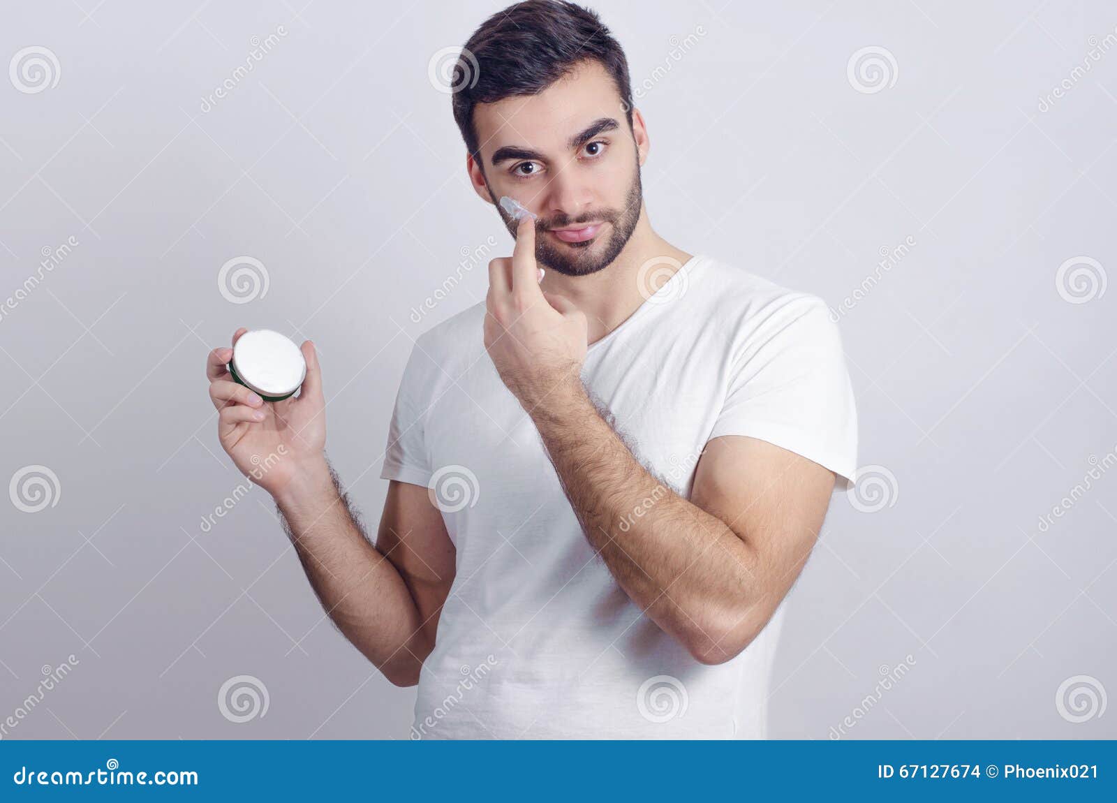 Handsome Young Man Putting Face Cream Stock Photo - Image of caucasian ...