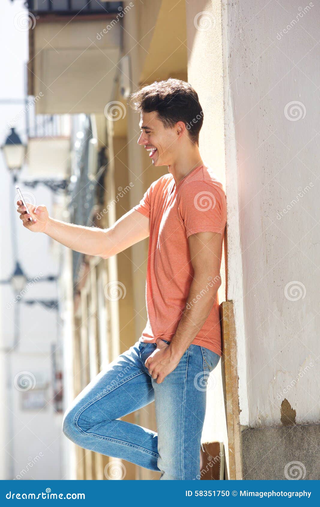 Handsome Young Man Reading Text Message on Cell Phone Stock Photo ...