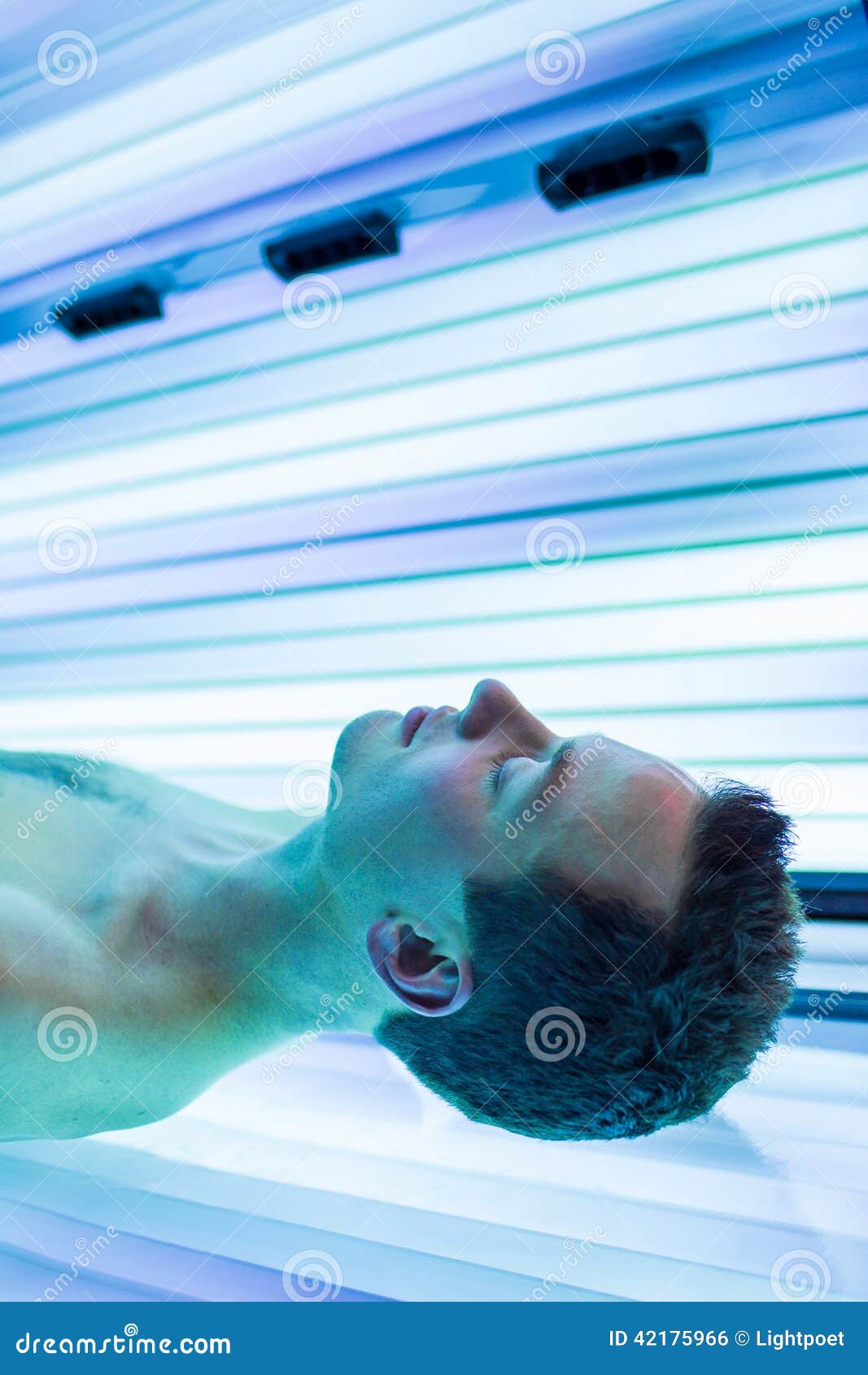 Handsome Young Man Relaxing during a Tanning Session Stock Photo ...