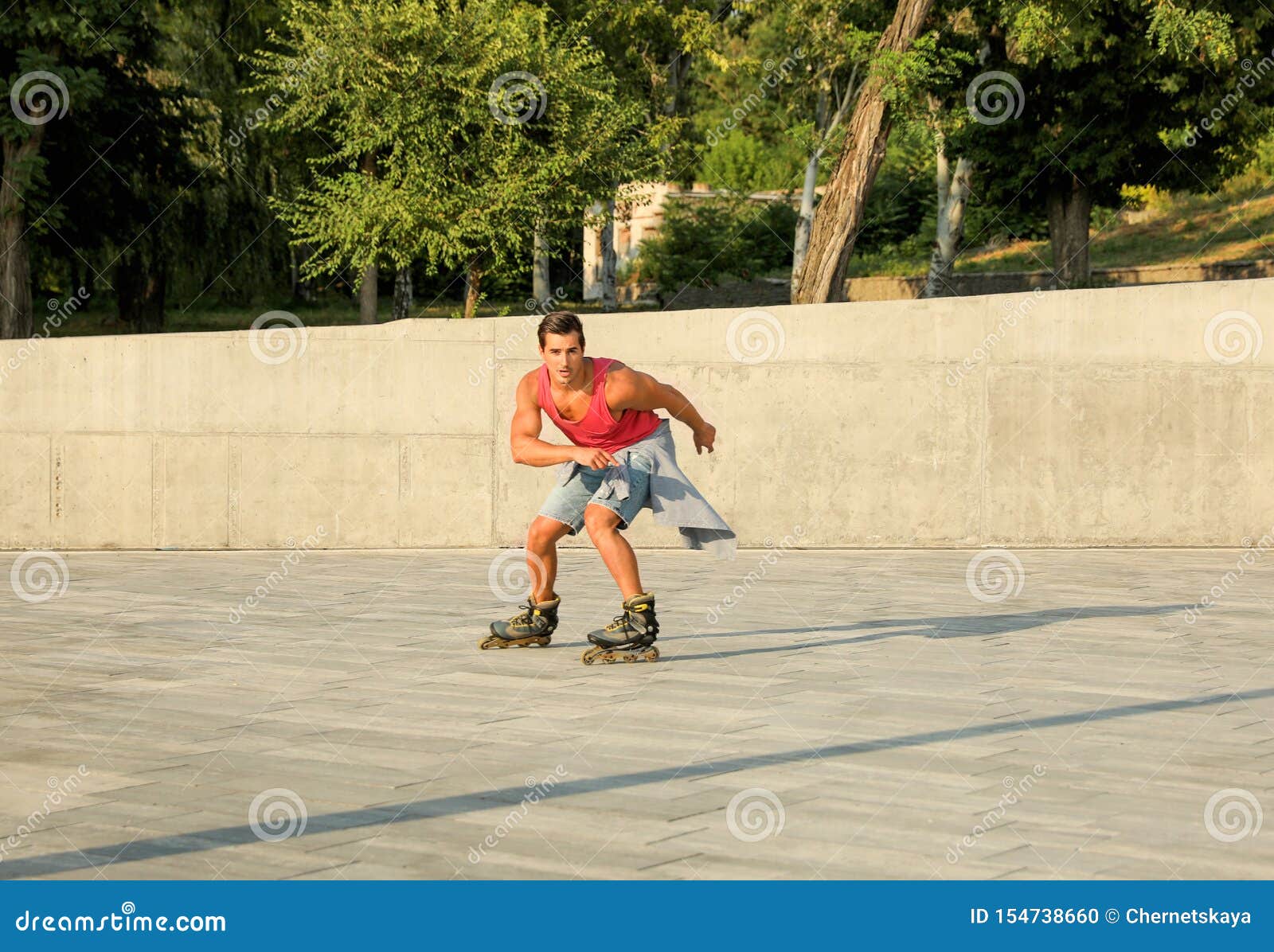 Handsome Young Man Roller Skating on City Street, Space for T Stock ...