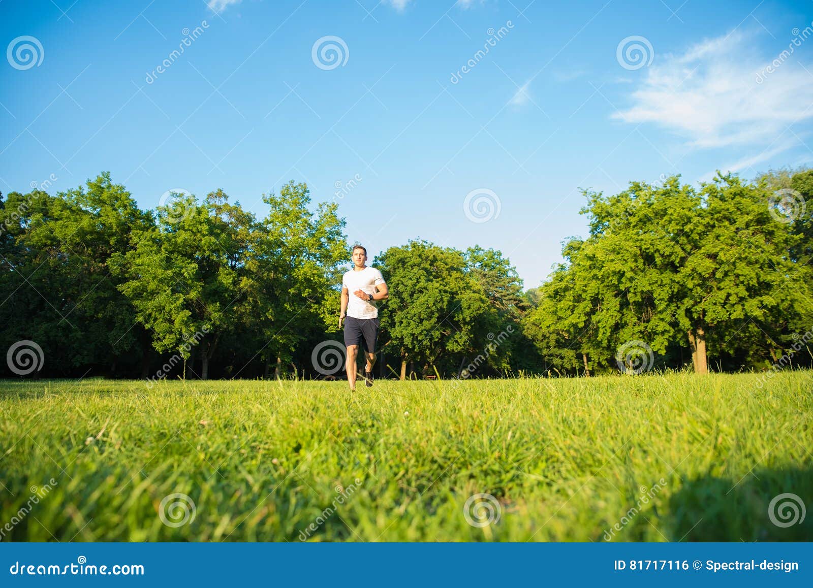 A Handsome Young Man Running in a Park Stock Photo - Image of exercise ...