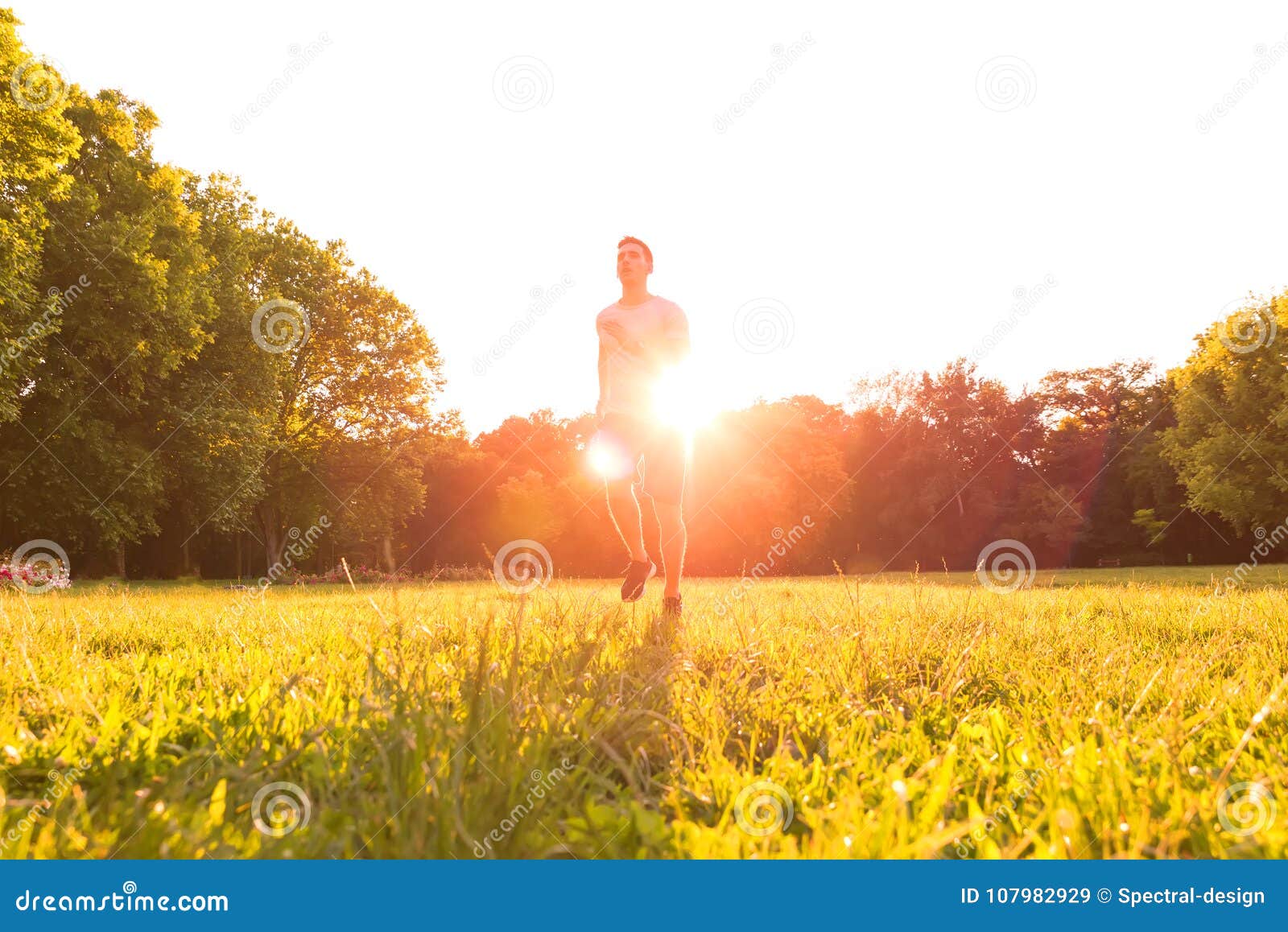 A Handsome Young Man Running during Sunset in a Park Stock Image ...