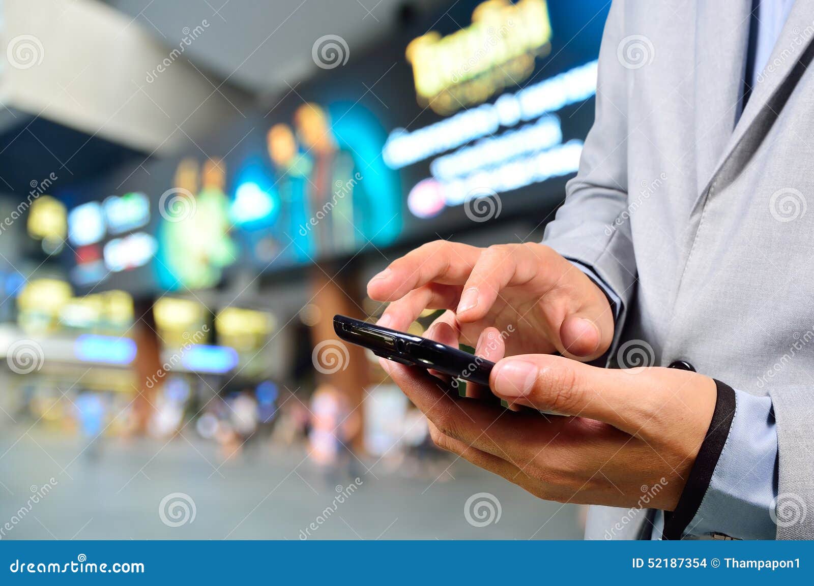 Handsome Young Man in Shopping Mall Using Mobile Phone Stock Photo ...