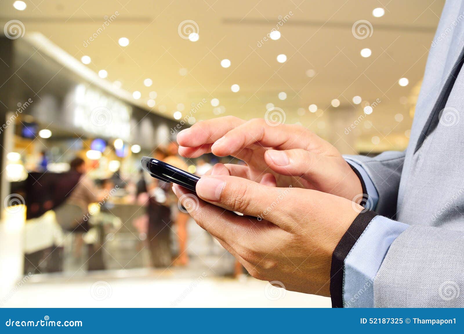 Handsome Young Man in Shopping Mall Using Mobile Phone Stock Image ...