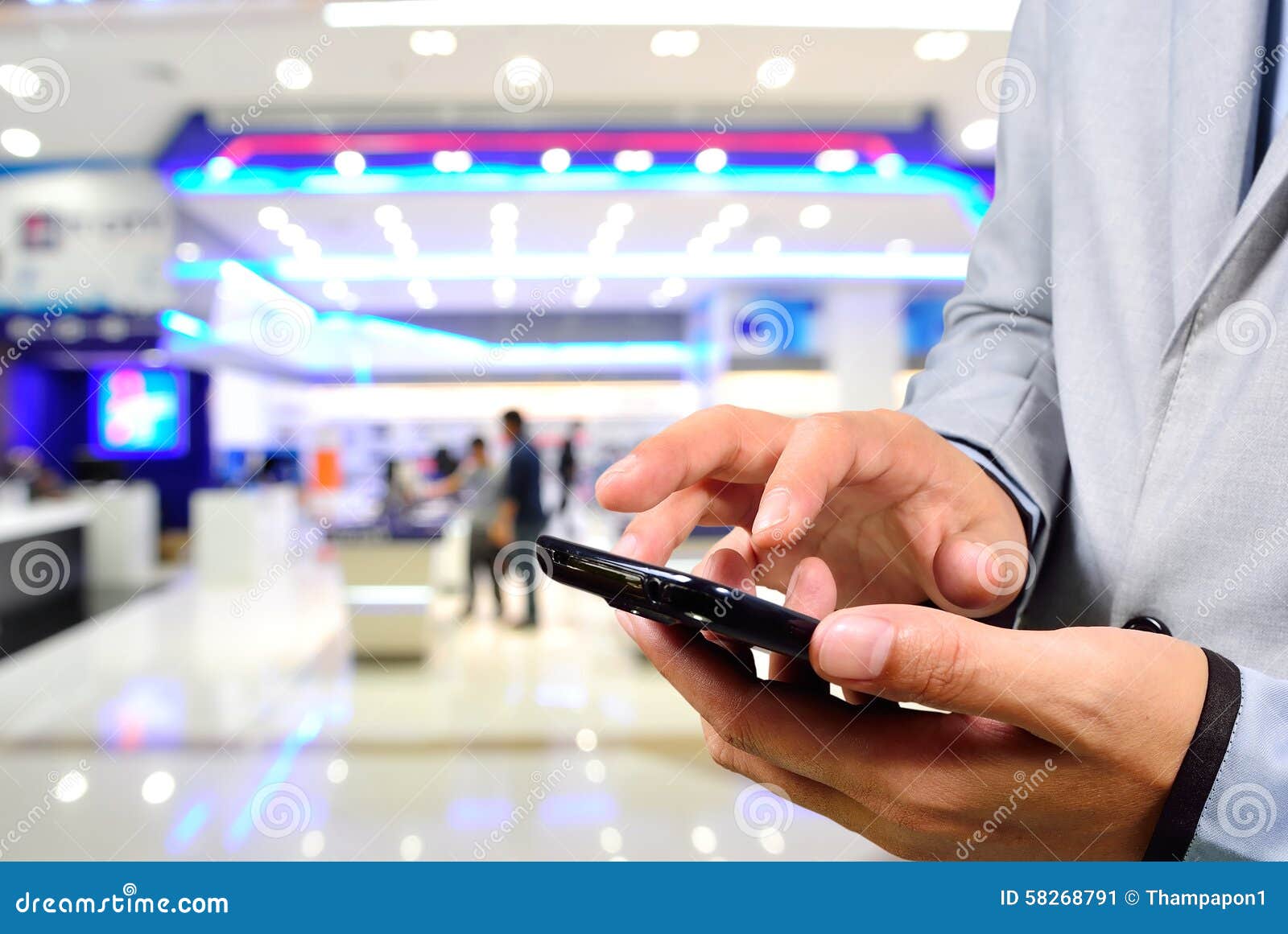 Handsome Young Man in Shopping Mall Using Mobile Phone. Stock Image ...