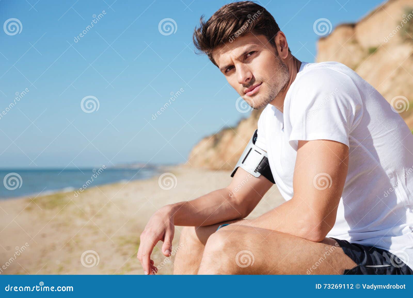 Handsome Young Man Sitting on the Beach Stock Photo - Image of body ...