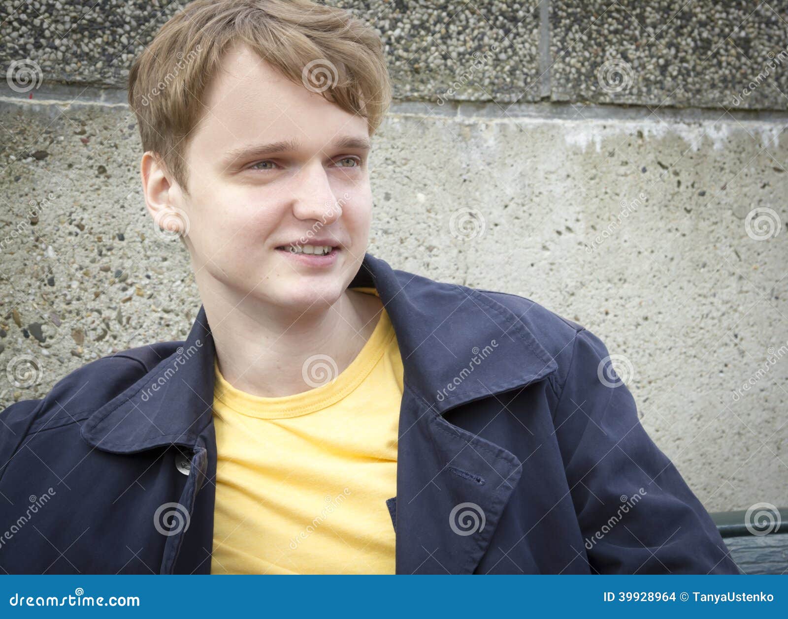 Handsome Young Man Sitting on a Bench Smiling Stock Photo - Image of ...