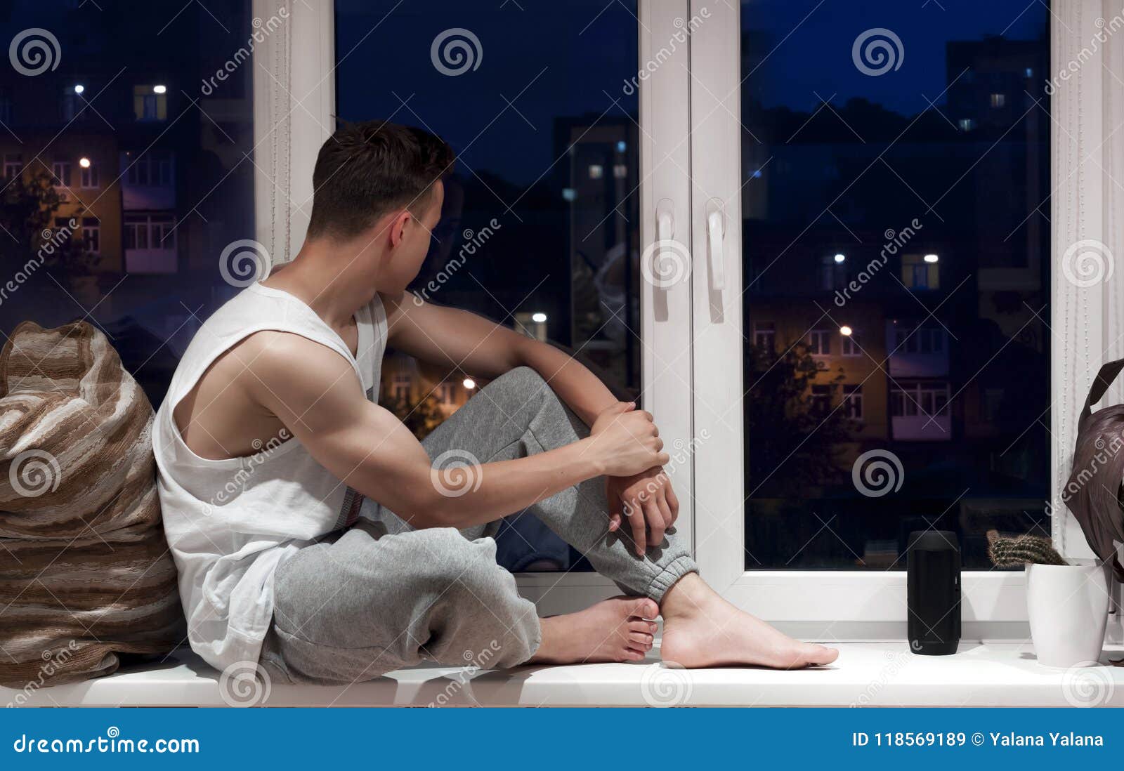 Handsome Young Man Sitting Near Window in the Evening Stock Image ...