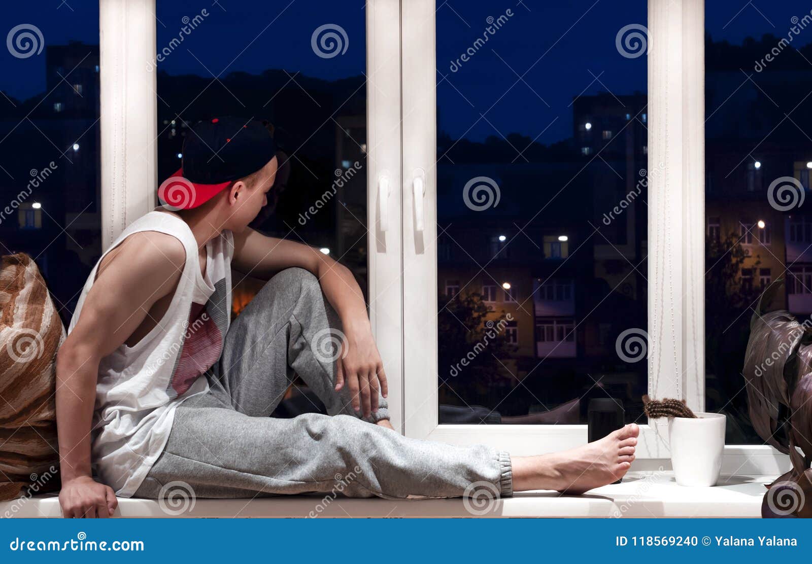 Handsome Young Man Sitting Near Window in the Evening Stock Photo ...